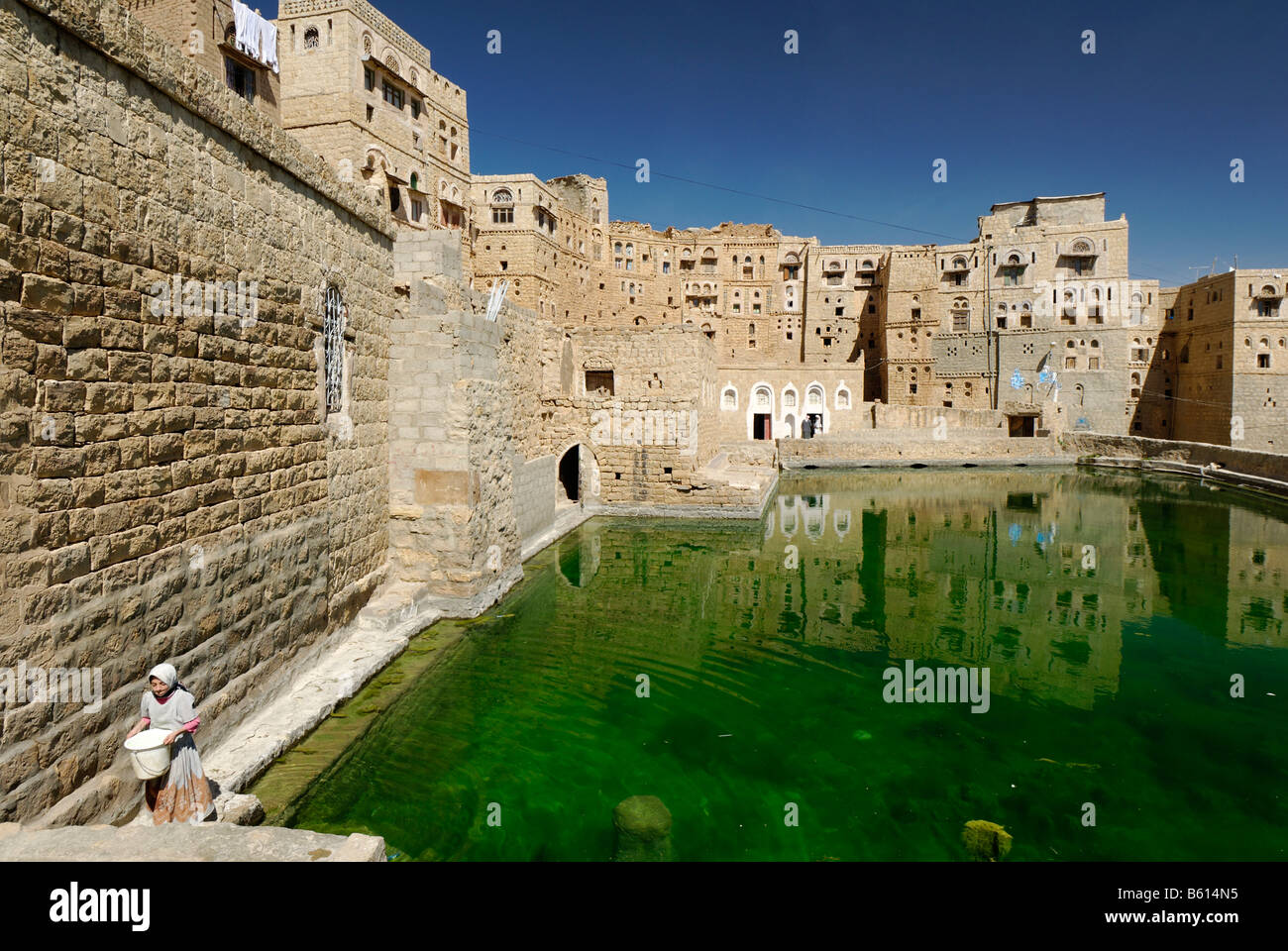Arabian girl fetching water from the Cistern in Habbaba, Yemen, Arabia ...