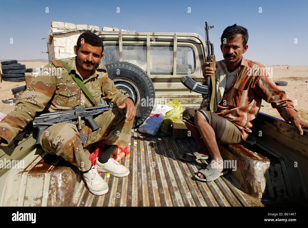 Soldiers with weapons sitting in a pickup, Marib, Yemen, Arabia ...