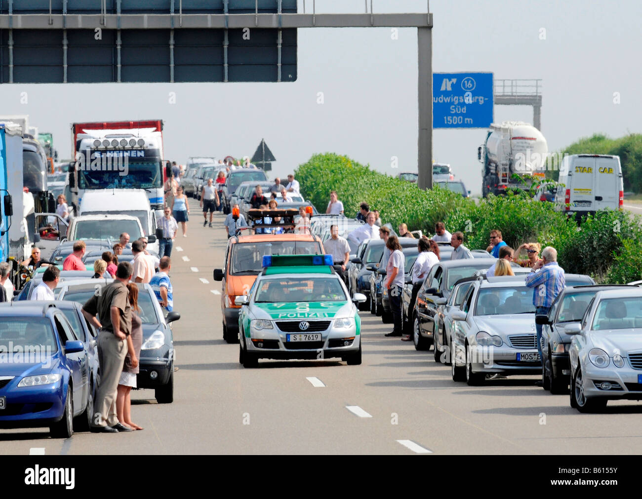 Traffic jam on a motorway, police car driving through a lane created by ...
