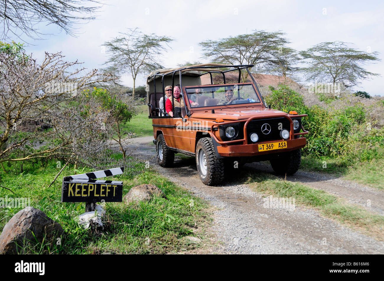 Tourists in a four wheel drive vehicle, safari to Hatari Lodge, former ...