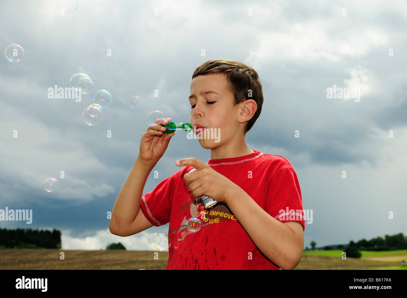 Nine-year-old boy blowing bubbles Stock Photo - Alamy