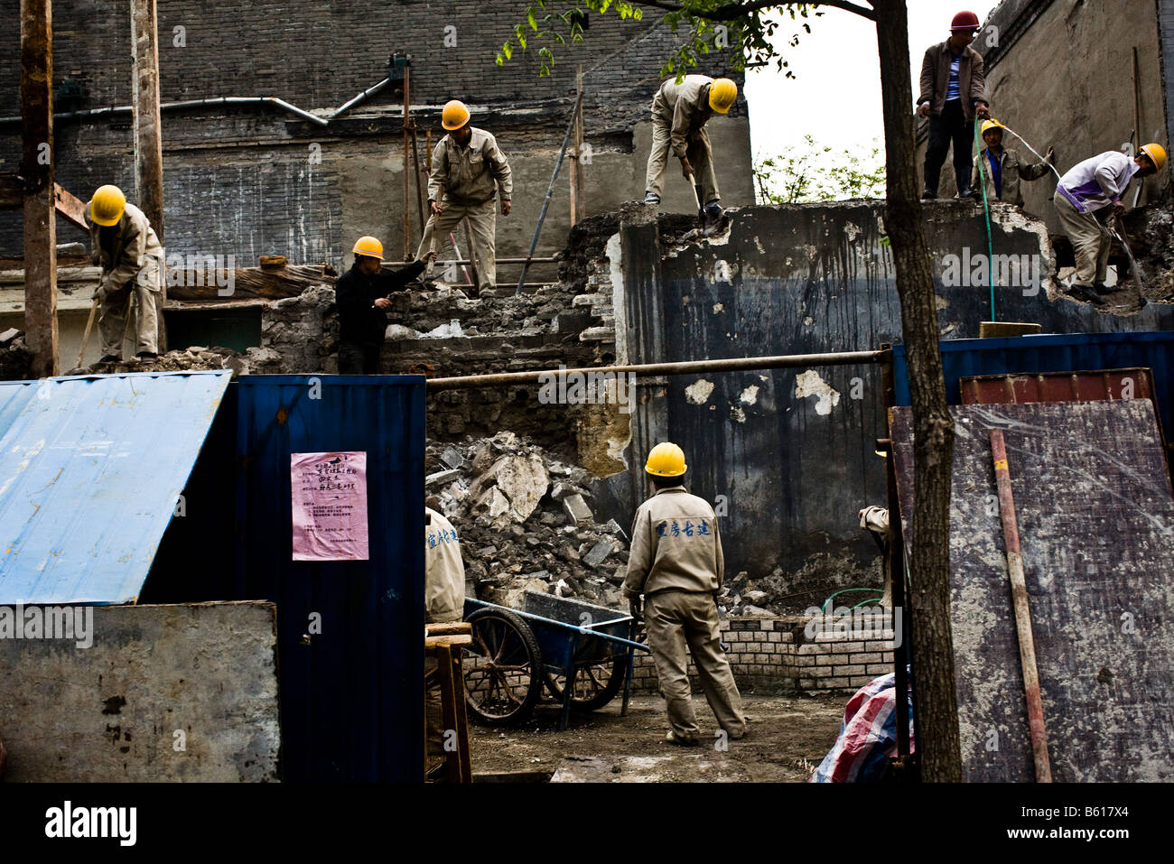 Workers disassemble part of a house in a hutong in Beijing China in ...