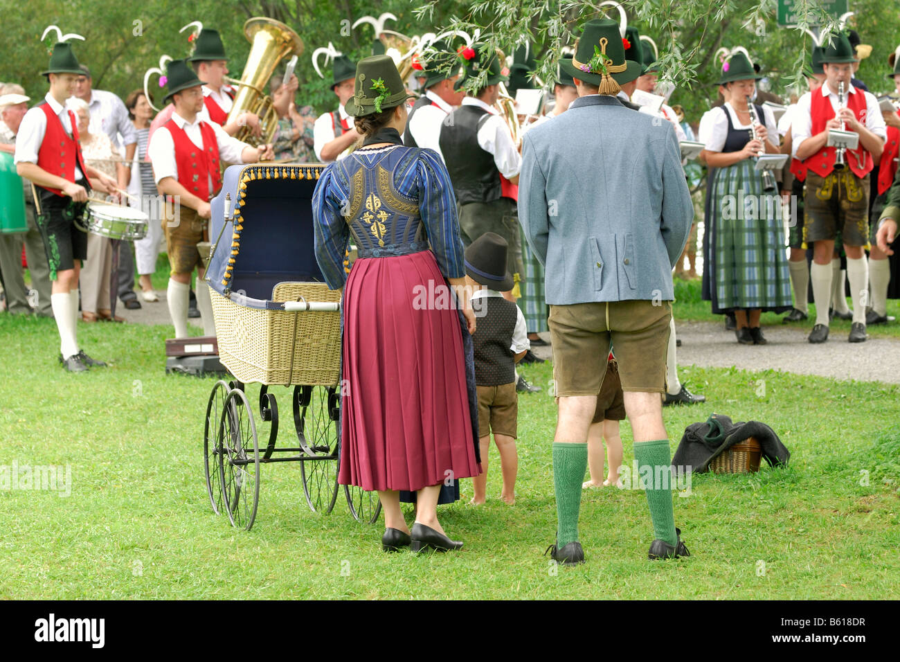 Family wearing traditional costumes with a historic pram at the Alt ...