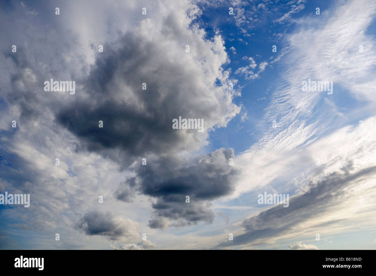 Rain clouds pushing their way in front of sunny weather clouds Stock ...