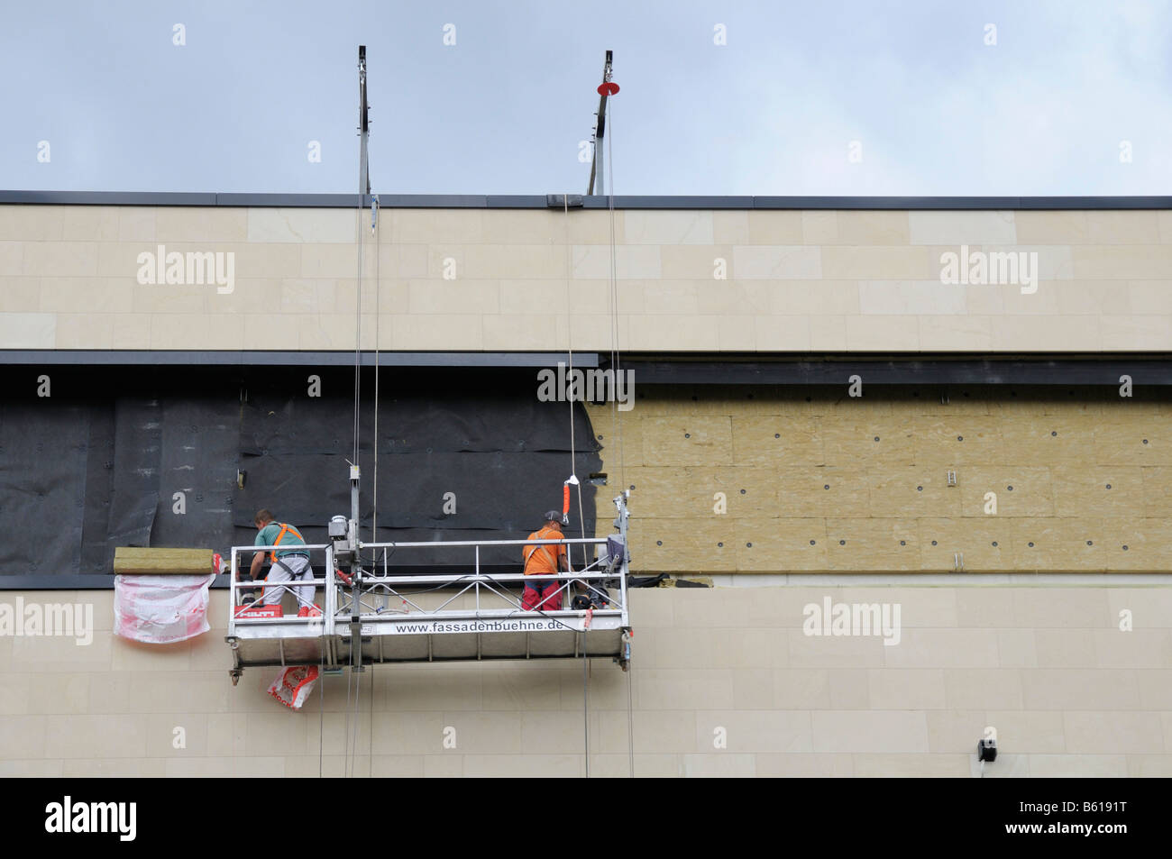 Workers working on building facade hi-res stock photography and images ...