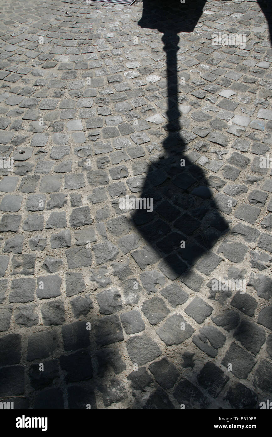 lamp post shadow on street road in rome, italy Stock Photo - Alamy