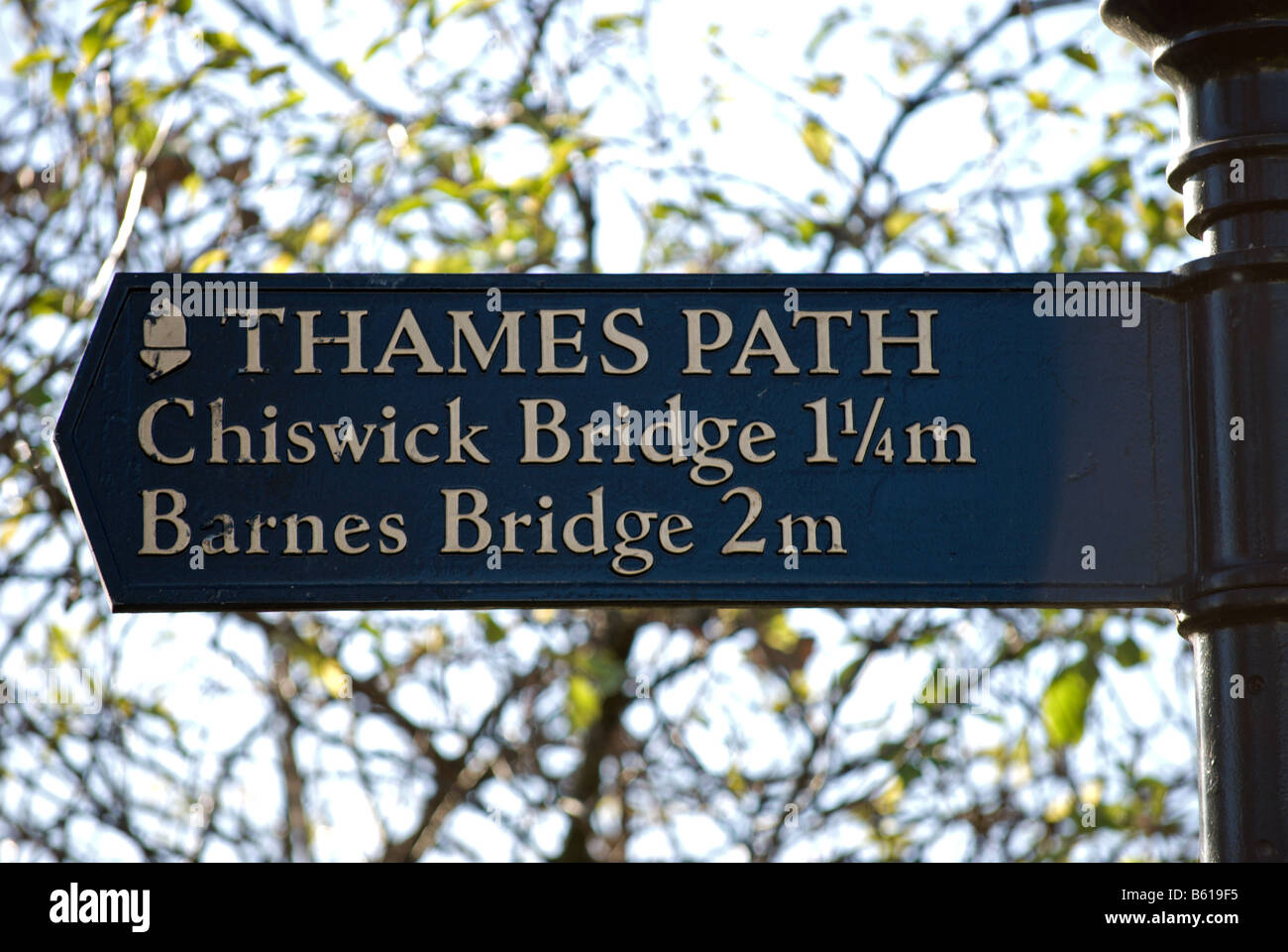 sign on the thames path showing directions to chiswick bridge and ...