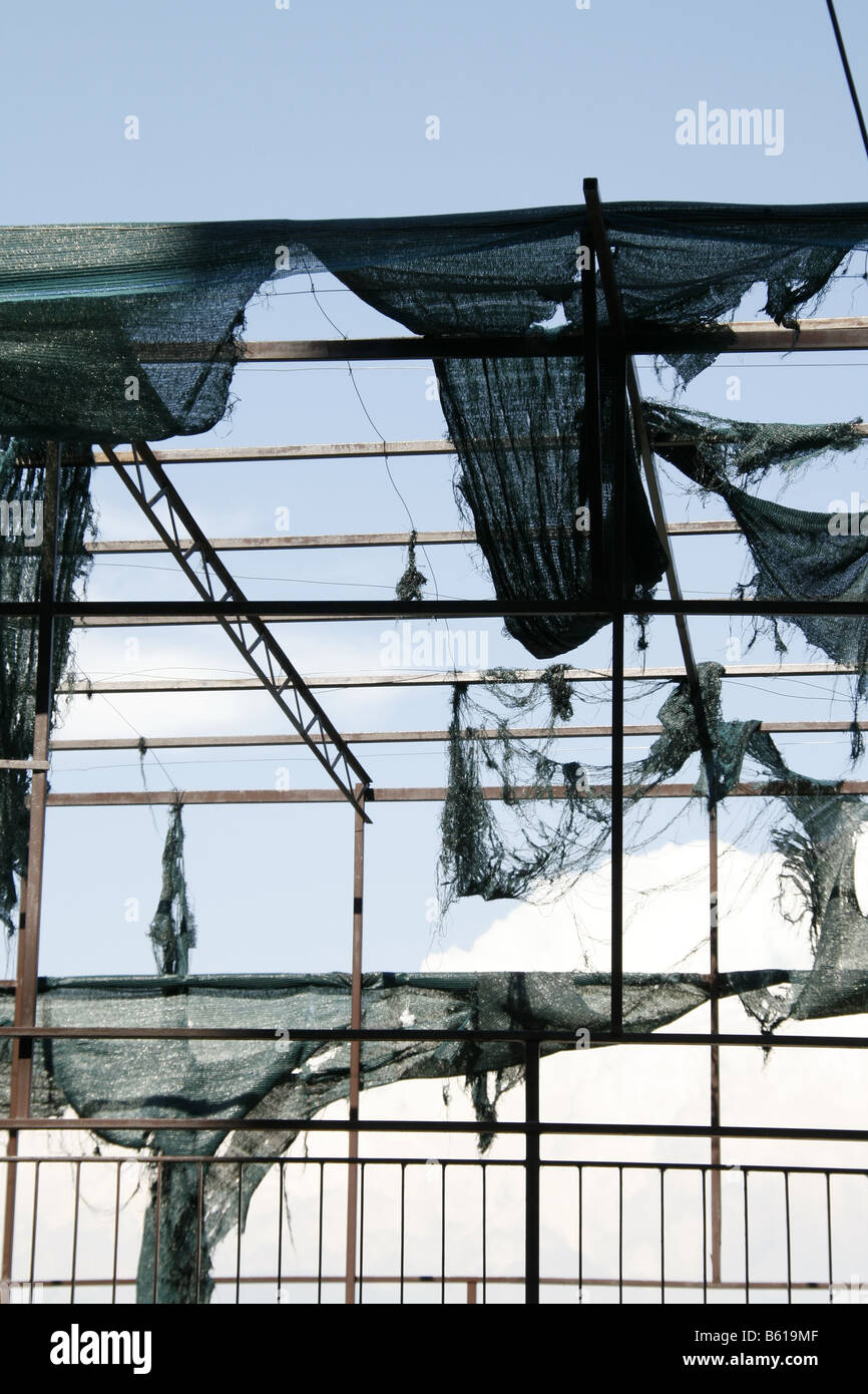 hanging old fabric on roof of metal scaffolding structure outdoors in ...