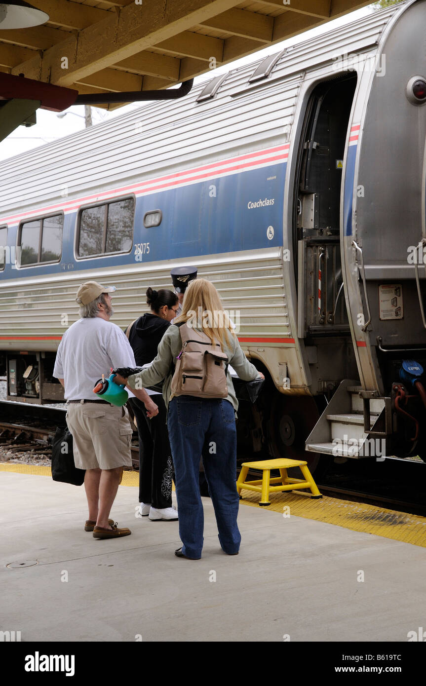 Railroad conductors assisting passengers onto hi-res stock photography ...