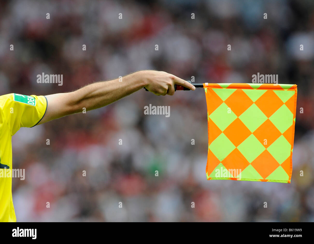 Referees assistant indicating offside with his flag Stock Photo - Alamy