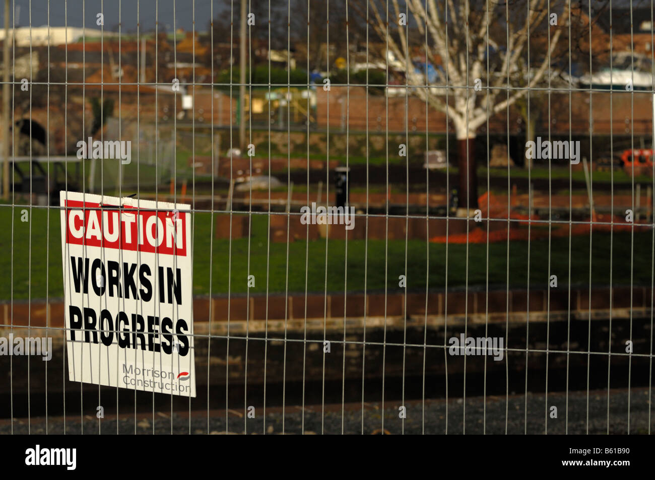 Fencing around building site with safety notice Stock Photo - Alamy