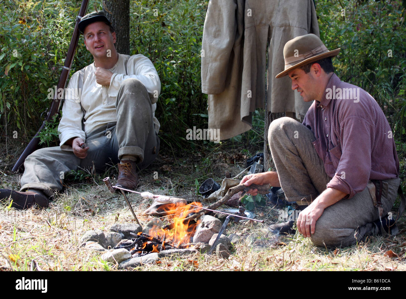 Confederate civil war soldiers making a campfire dinner during a Civil ...