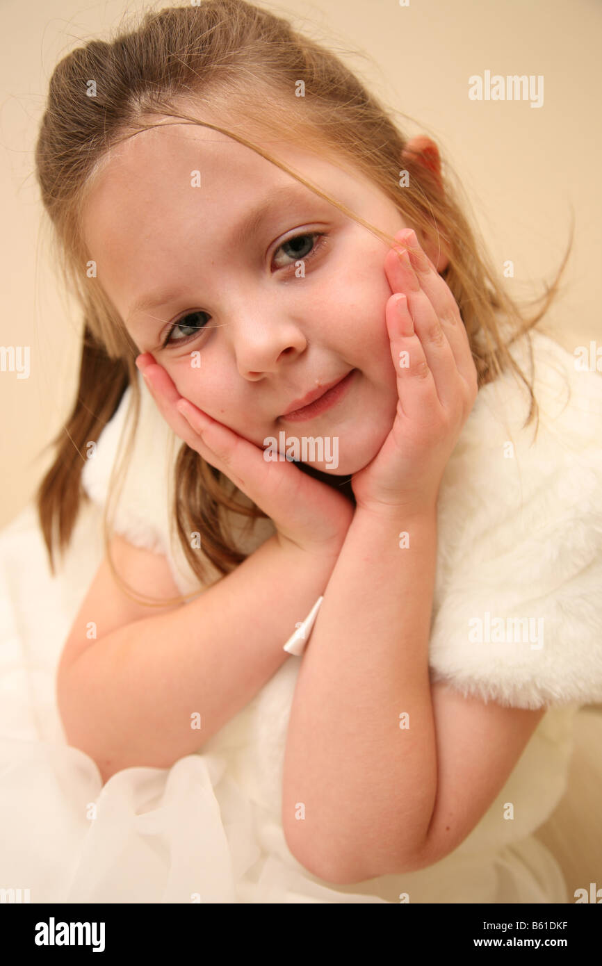 Angelic child looking very sweet and innocent Stock Photo - Alamy