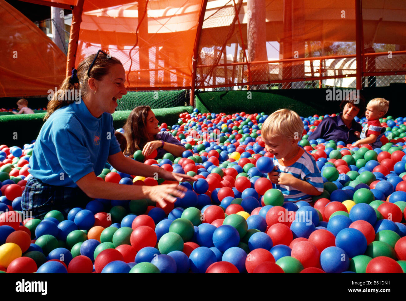 Children & adults playing in the 'Snuffleballs' at Sesame Place, a ...