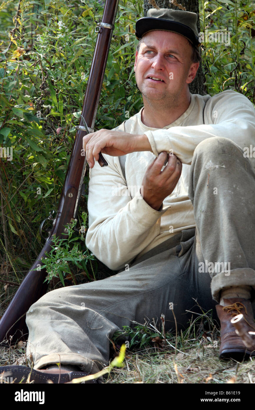 Confederate civil war soldier making a campfire dinner during a Civil ...