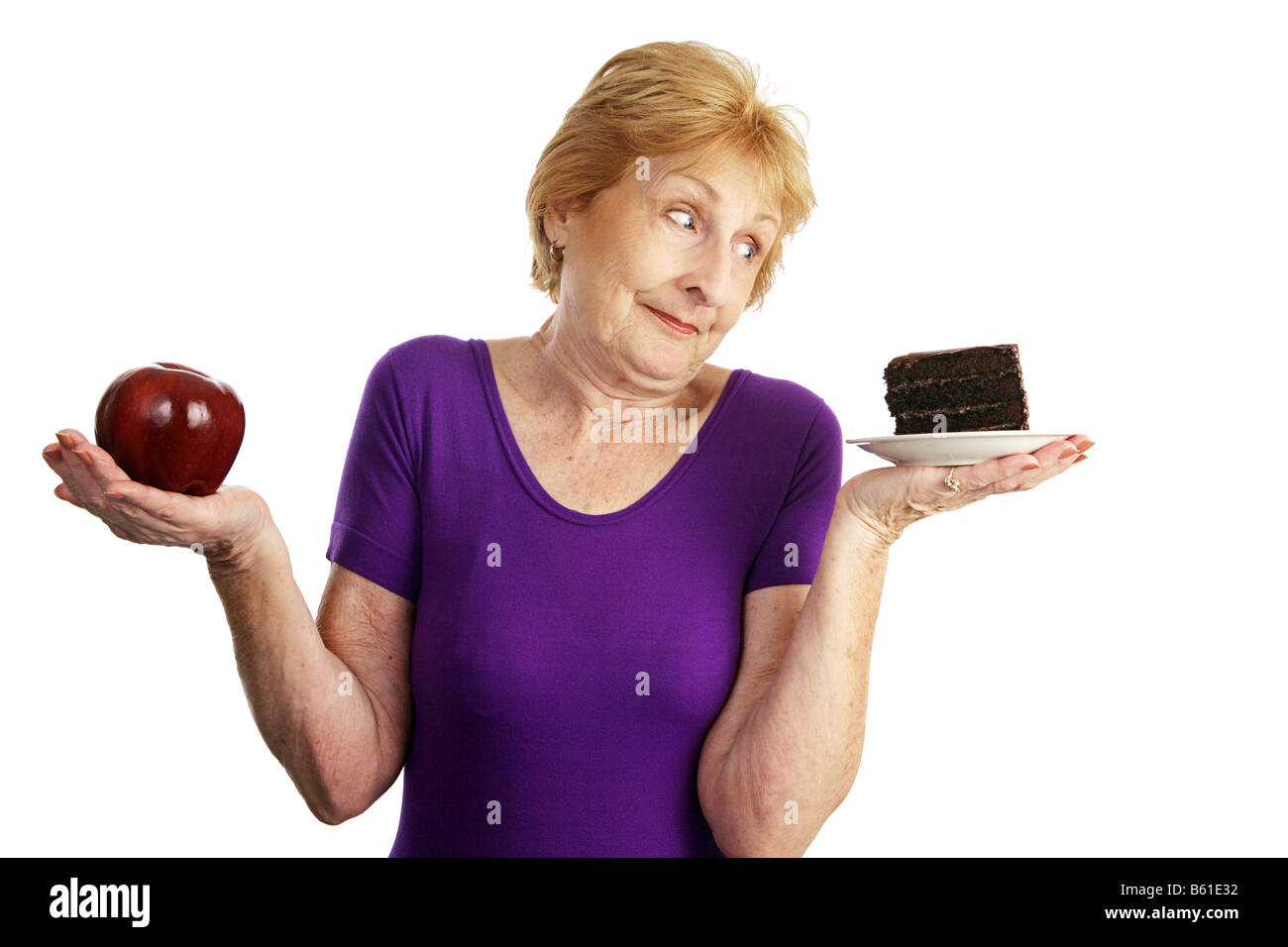Fit senior woman making food choices She is unable to resist the ...
