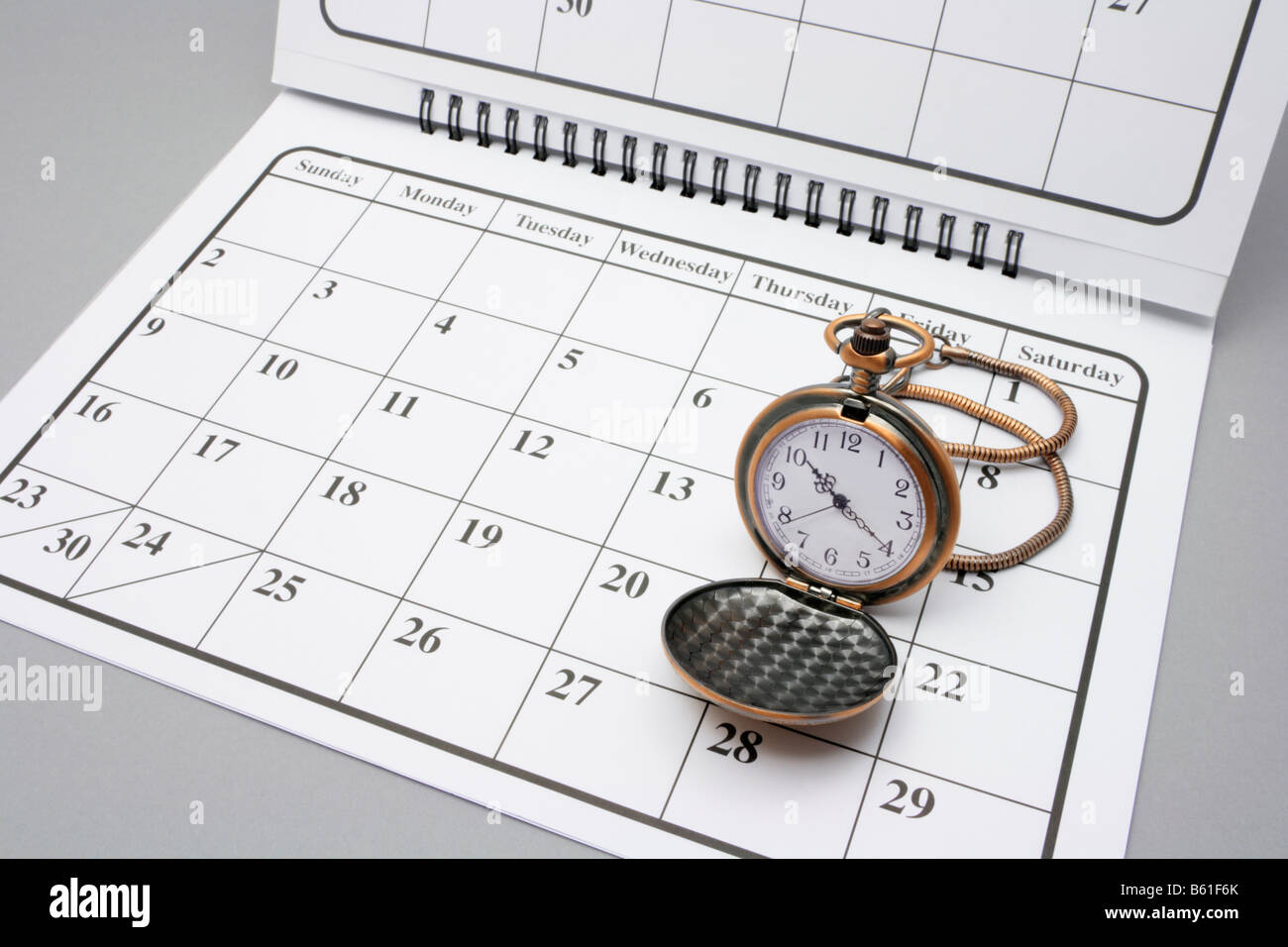 Pocket Watch on Calendar Stock Photo - Alamy