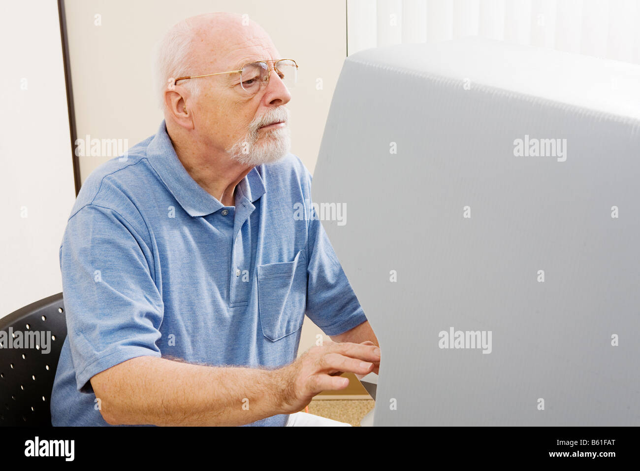 Senior man with hearing and vision impairment voting on new touch ...