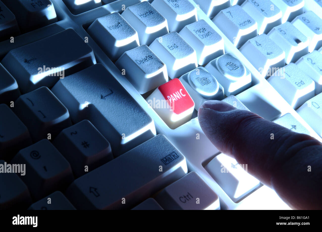 a man pressing the panic button on a keyboard Stock Photo - Alamy
