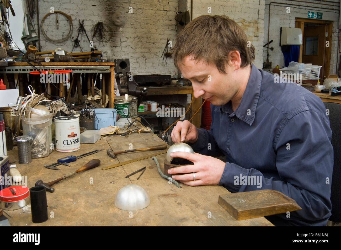 Silversmith Christopher Perry at his workshop in Sheffield Stock Photo ...