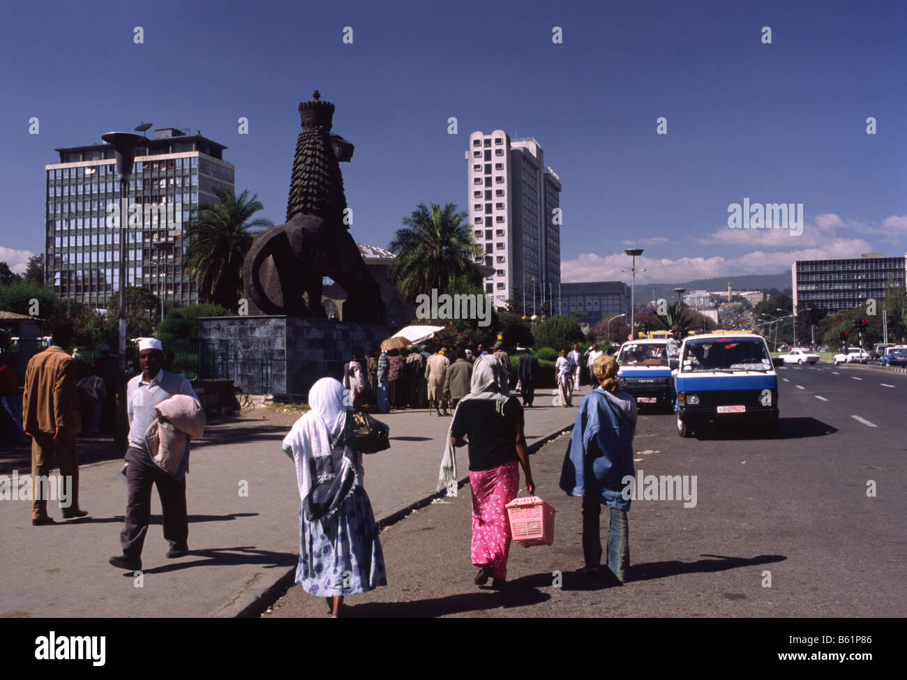 Street life in Addis Ababa Ethiopia with the lion statue on the left ...