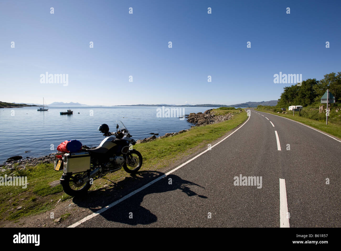 Touring BMW motorcycle parked by sweeping coastal highway in the ...