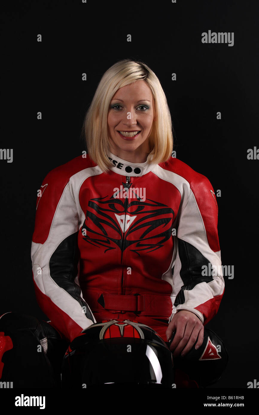 Young woman wearing leathers and carrying a crash helmet Stock Photo ...