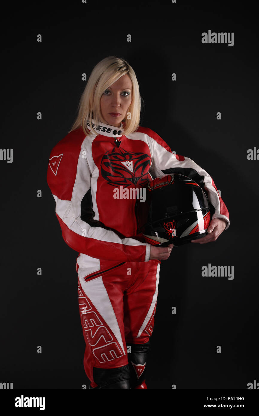 Young woman wearing leathers and carrying a crash helmet Stock Photo ...