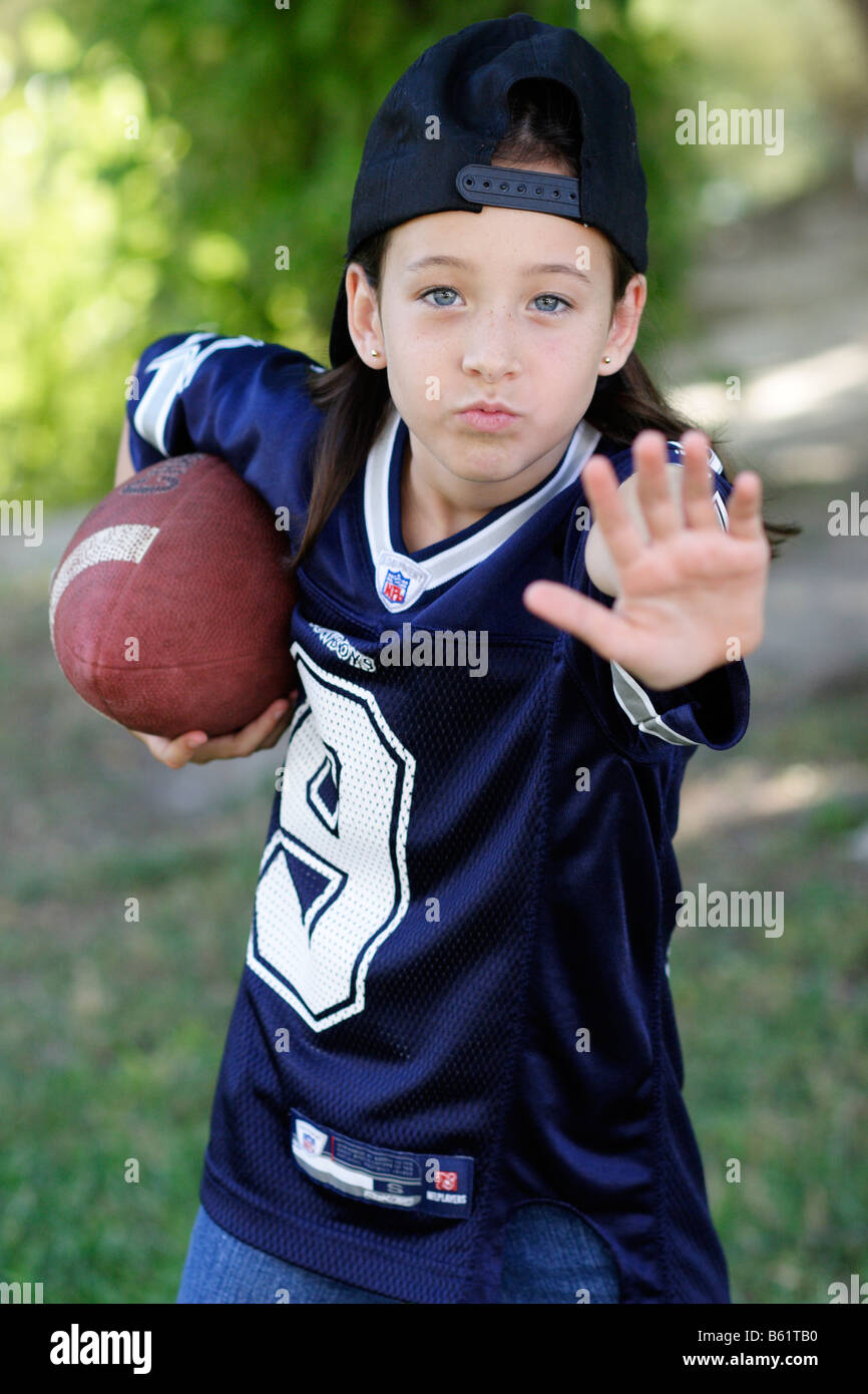 A young girl with a football and arm out to block Stock Photo - Alamy