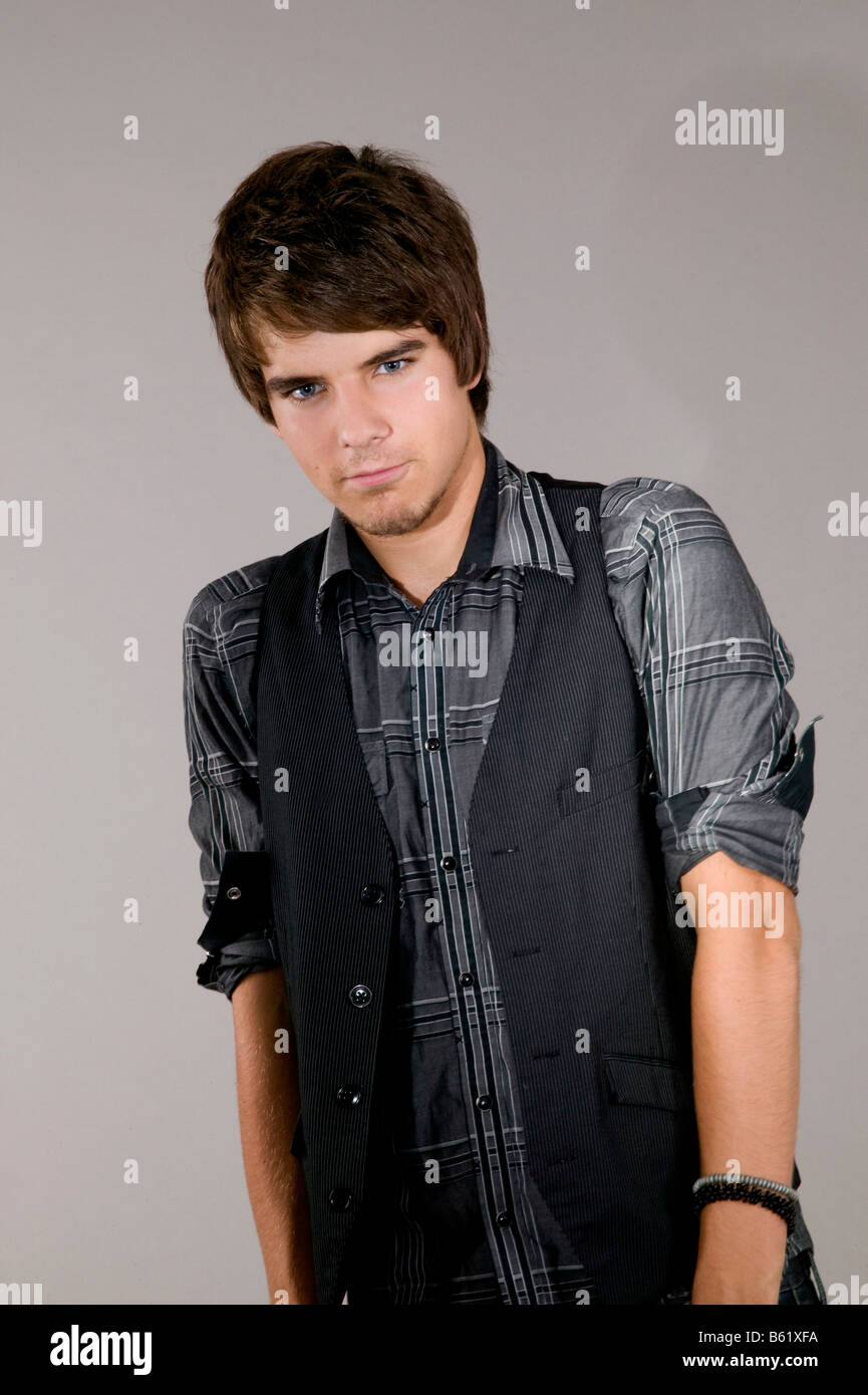 Young man looking questioningly at the photographer Stock Photo - Alamy