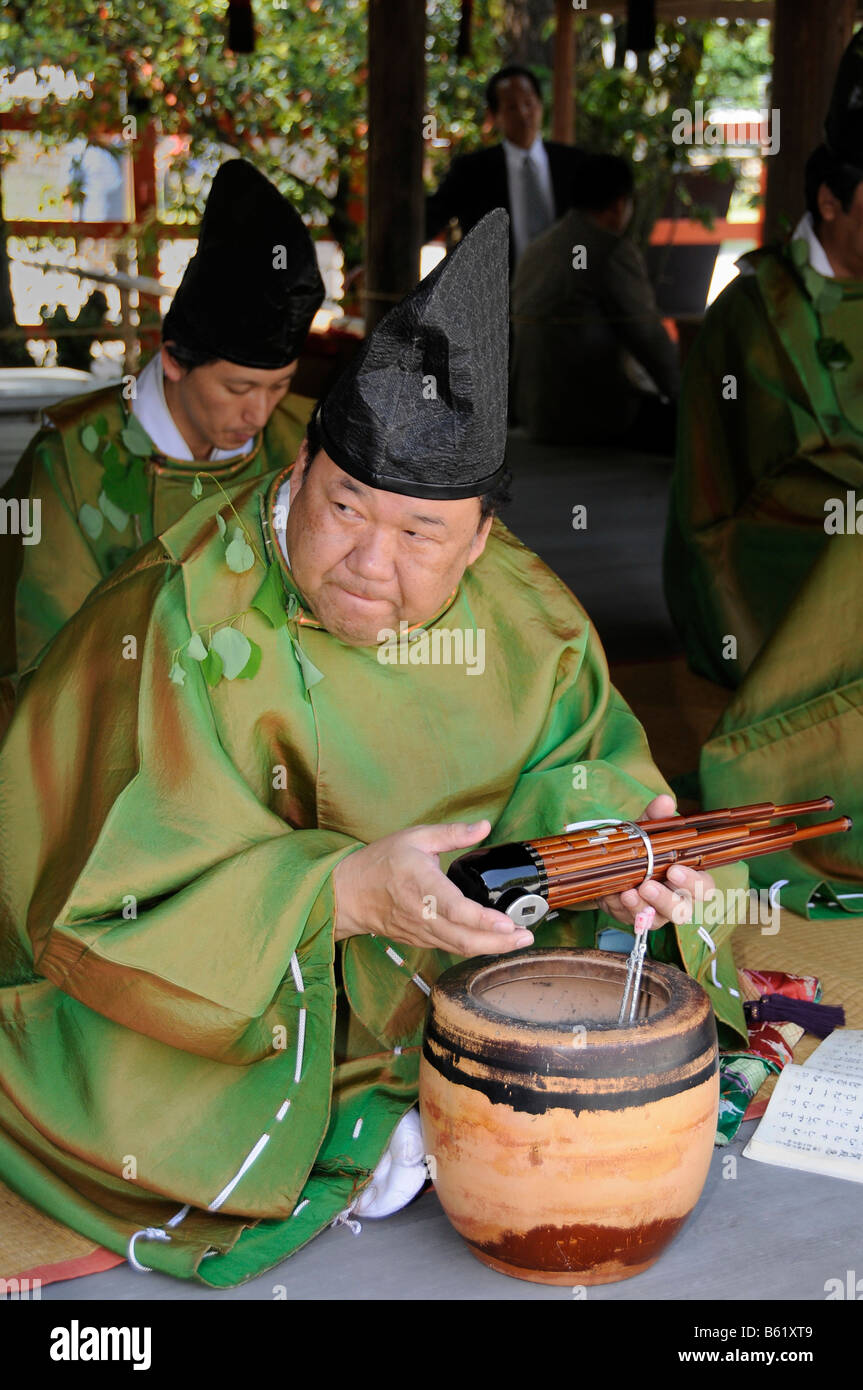 Musicians at the Aoi Festival holding a Sho wooden mouth organ in the ...