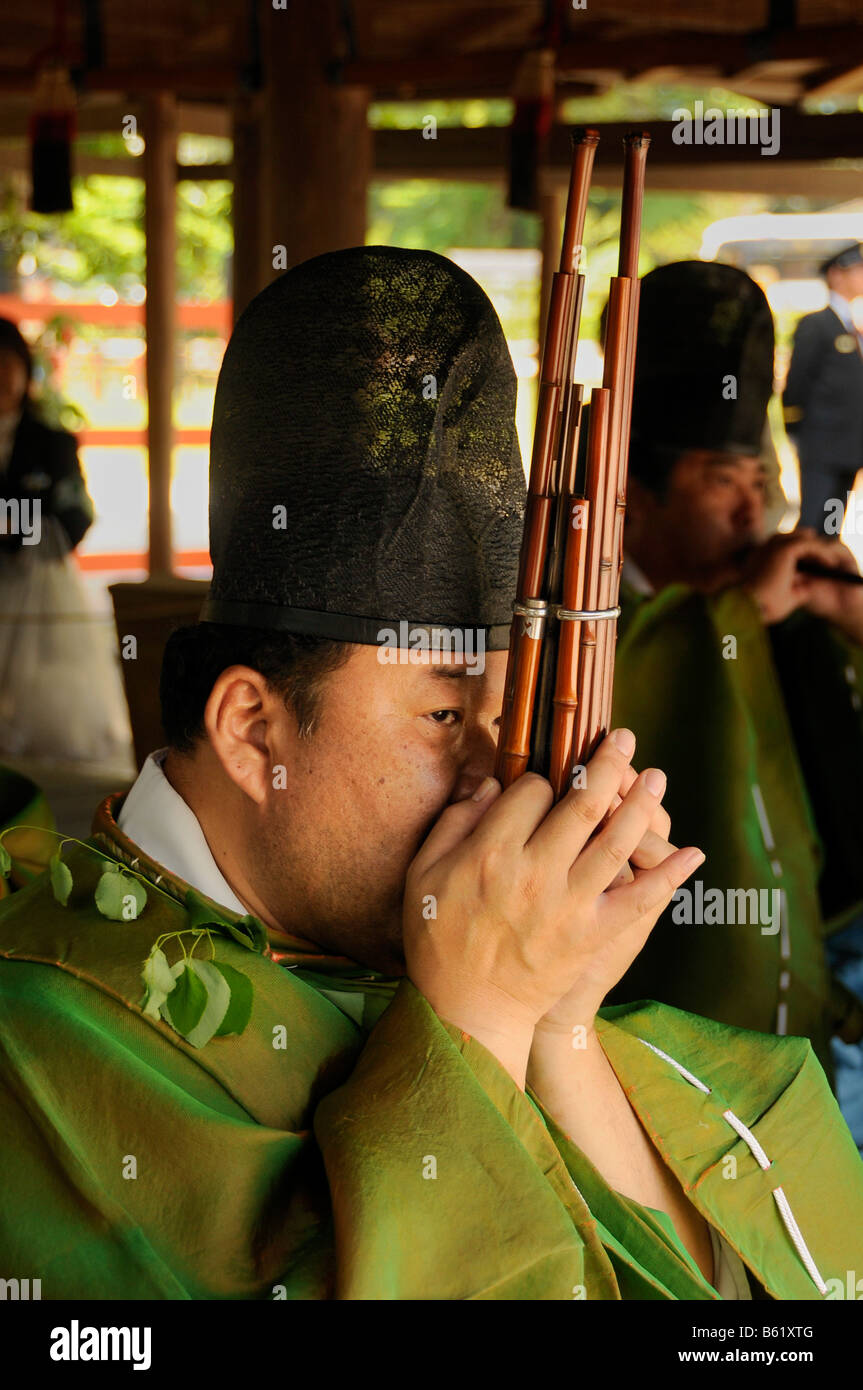 Musicians at the Aoi Festival playing a Sho wooden mouth organ in the ...