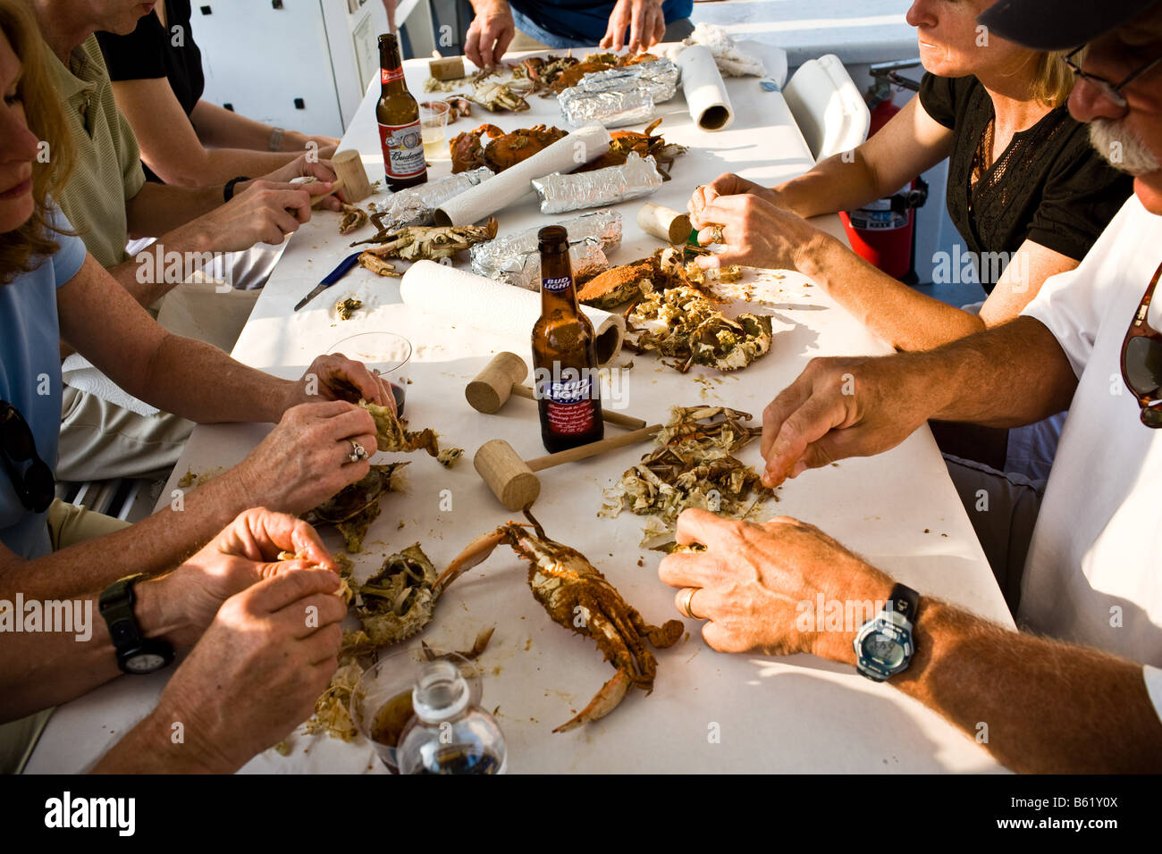 People enjoy the sunset while eating steamed shrimp and crabs along the ...