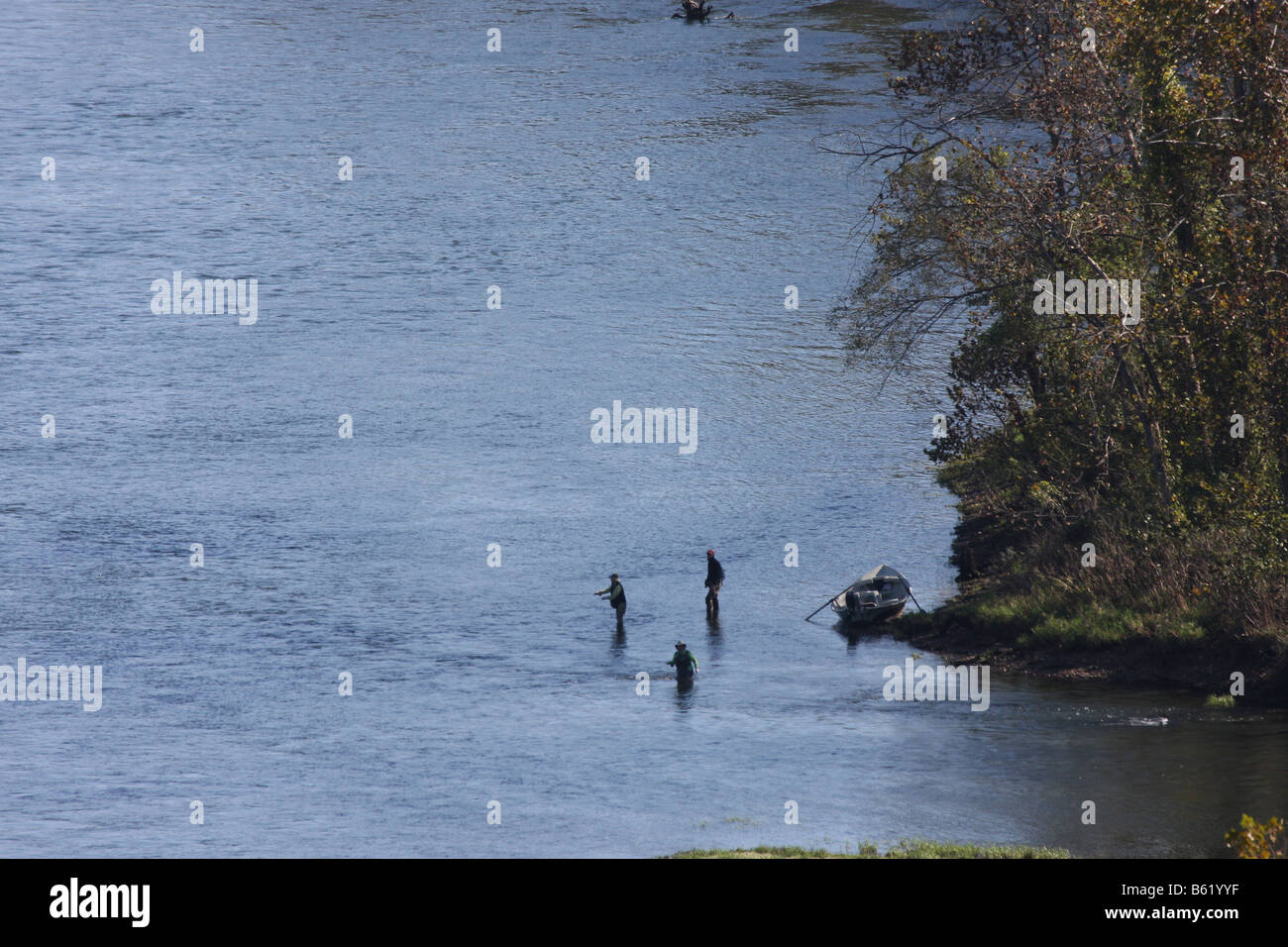 Three Fly Fishermen on the bank of Lake Taneycomo and another flowage ...
