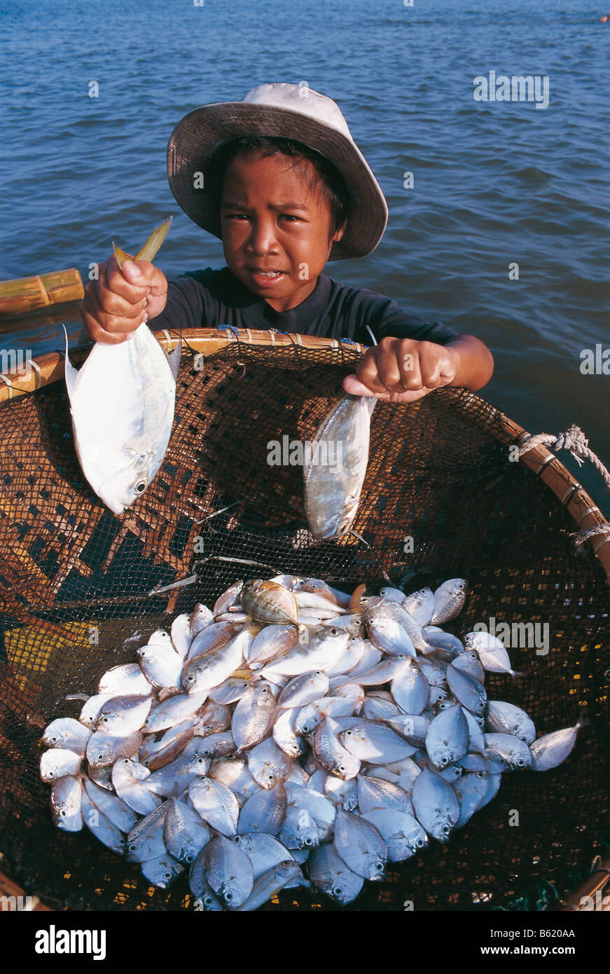 Boy with caught fish Stock Photo - Alamy