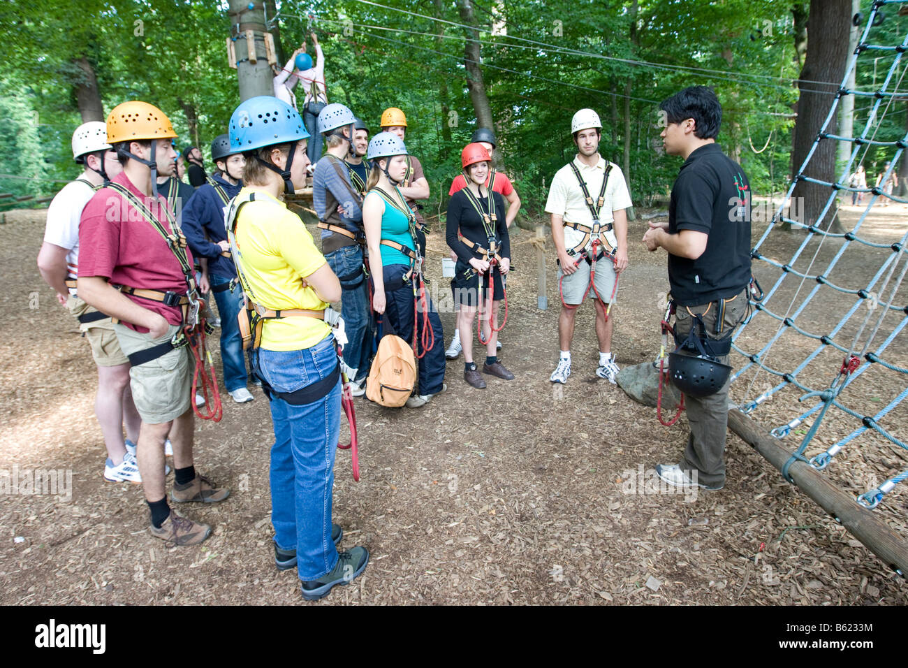 Instructor explaining how to climb at a ropes course, Kletterwald ...