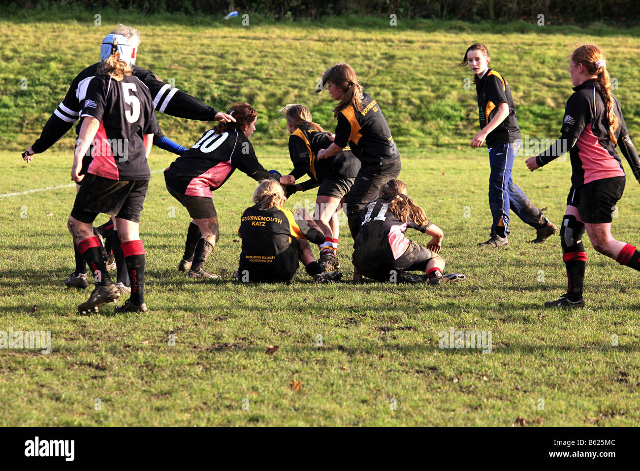 Teenage girls playing Rugby on a cold wet autumn afternoon Stock Photo ...
