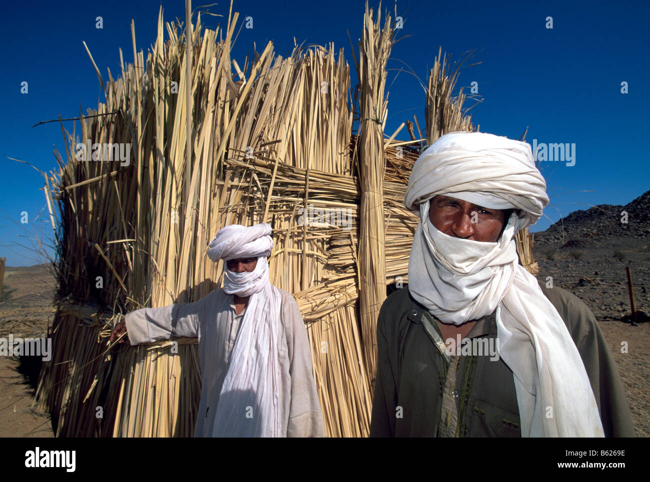 Touareg men in front of a reed hut, Ahaggar National Park, Ahaggar ...
