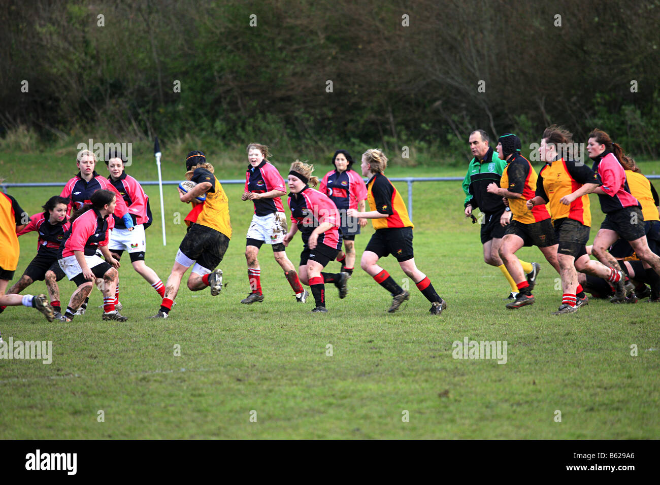 Teenage girls playing Rugby on a cold wet autumn afternoon Stock Photo ...