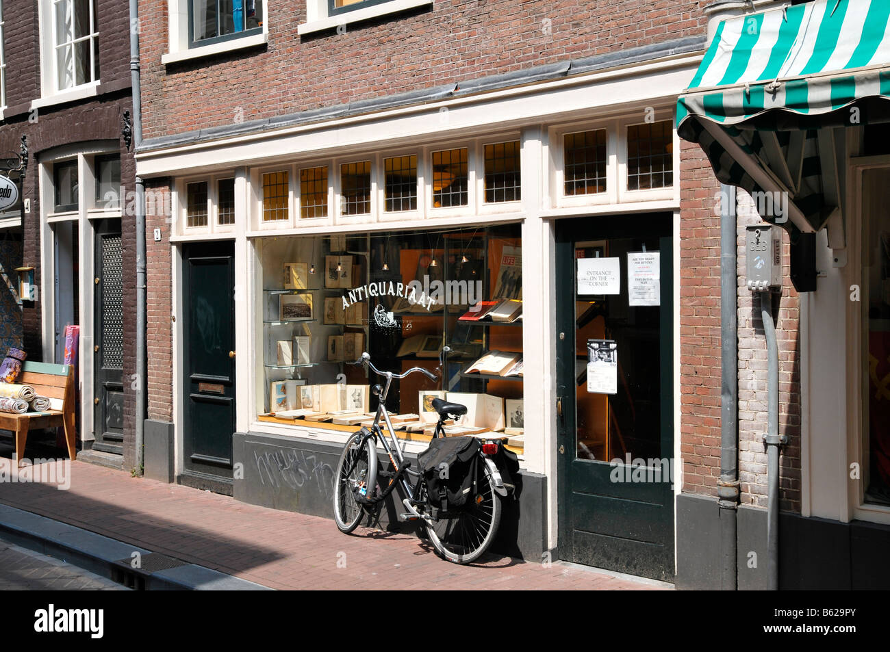 Bicycle in front of an antique shop window display, Oude Spiegelstraat ...