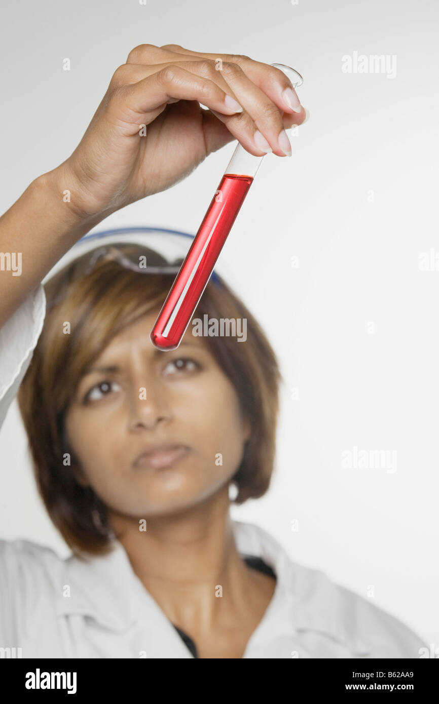Laboratory worker holding up a test tube Stock Photo - Alamy