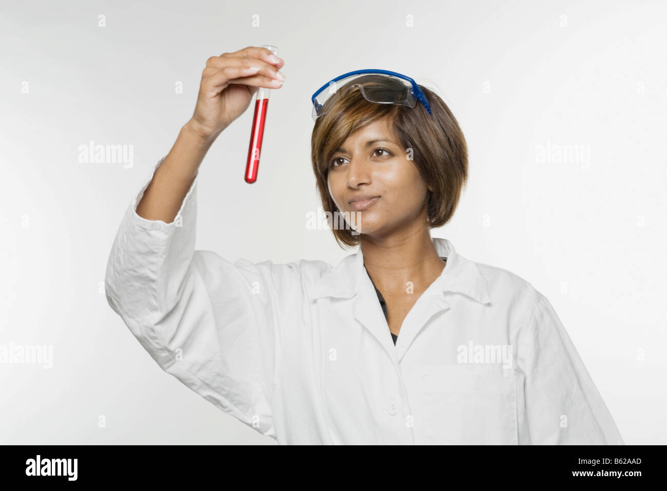 Laboratory worker holding up a test tube Stock Photo - Alamy