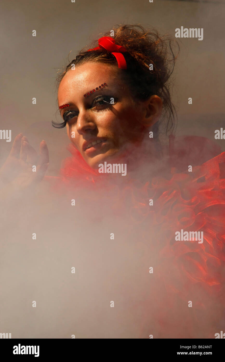 Dancer shrouded in mist during the Highway to Love 2008 Love Parade in ...