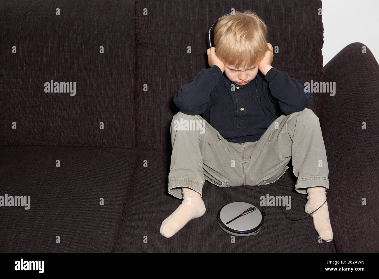 Little boy sulking on a couch Stock Photo - Alamy