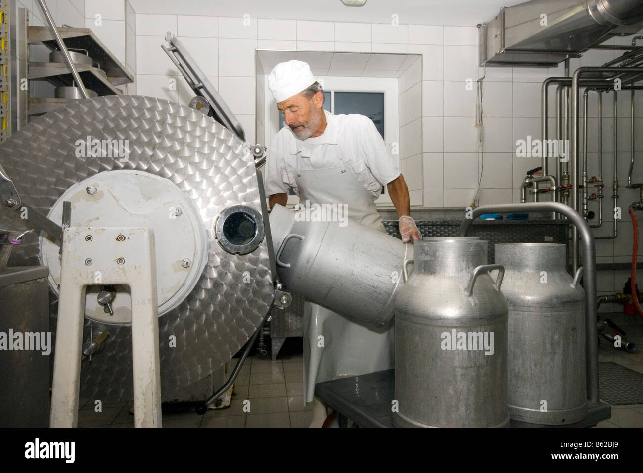 Cheesemaker pours milk hi-res stock photography and images - Alamy