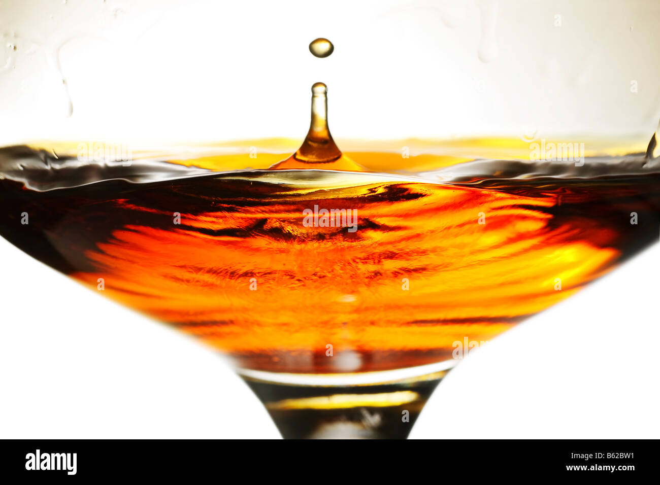 brandy splash in a snifter glass Stock Photo - Alamy