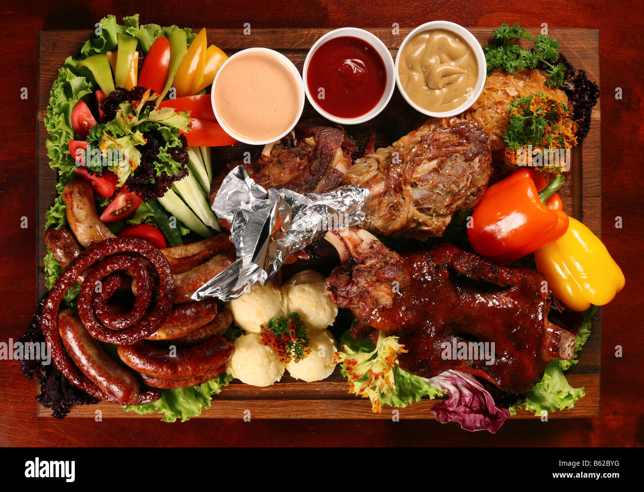 Grilled mix meat with sausage and vegetable front view Stock Photo - Alamy