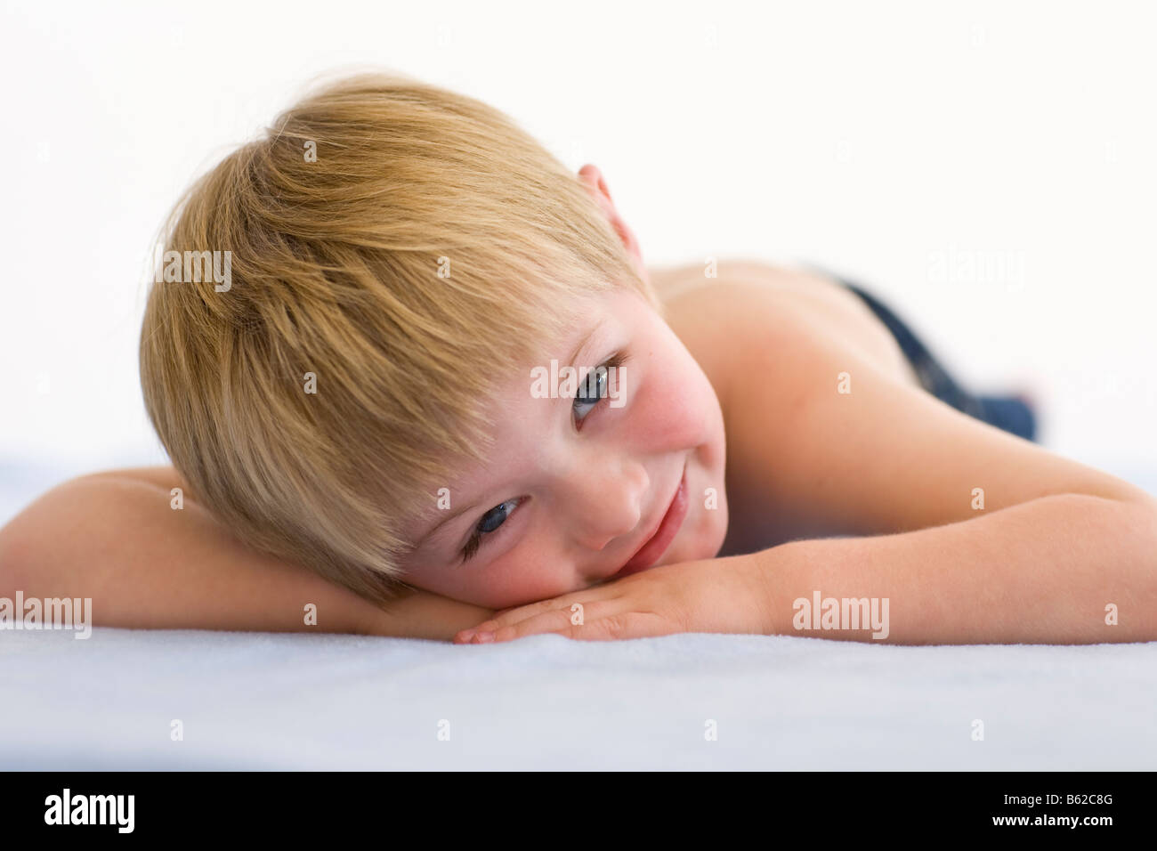 little boy laying on floor Stock Photo - Alamy