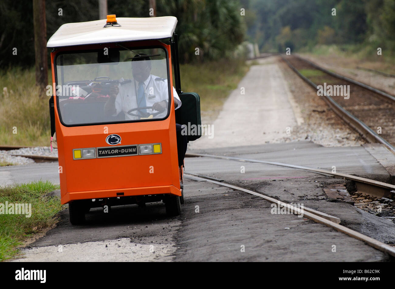 Amtrak porter driving electric cart with passengers luggage on board ...