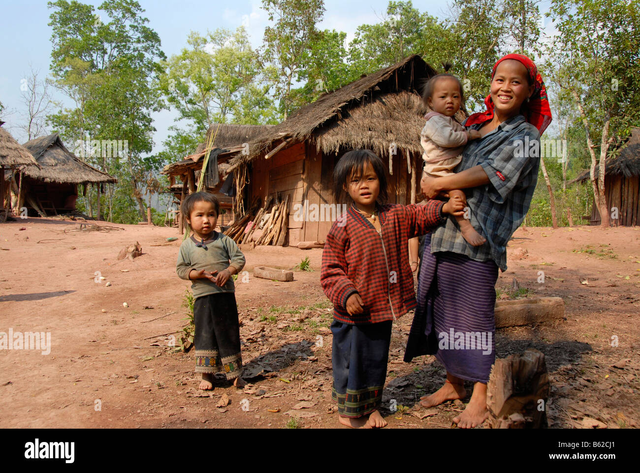 Poverty, a smiling mother with her children in the village, Xieng ...